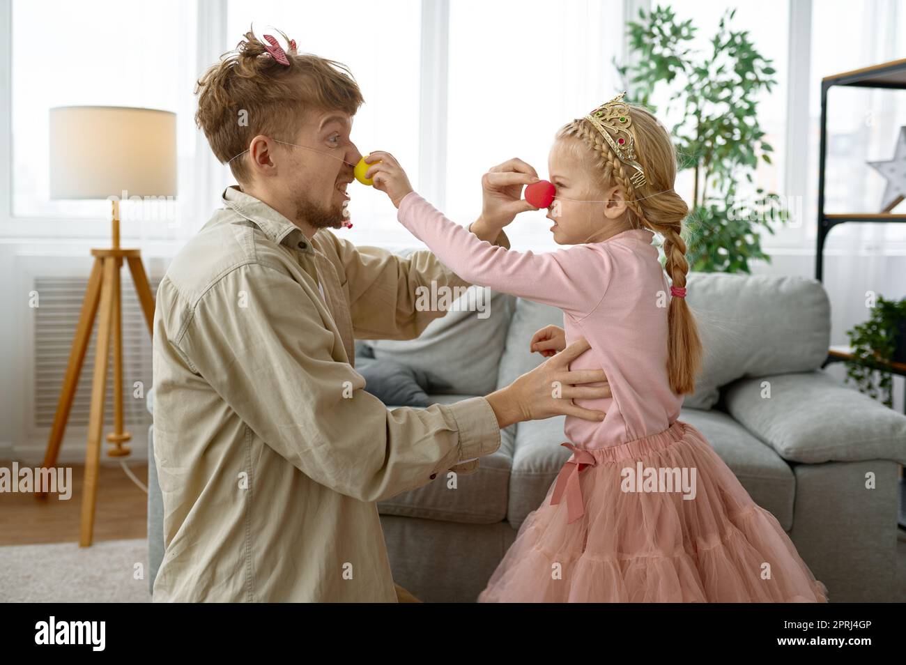 Dad and daughter wearing clown nose having fun together, happy family ...