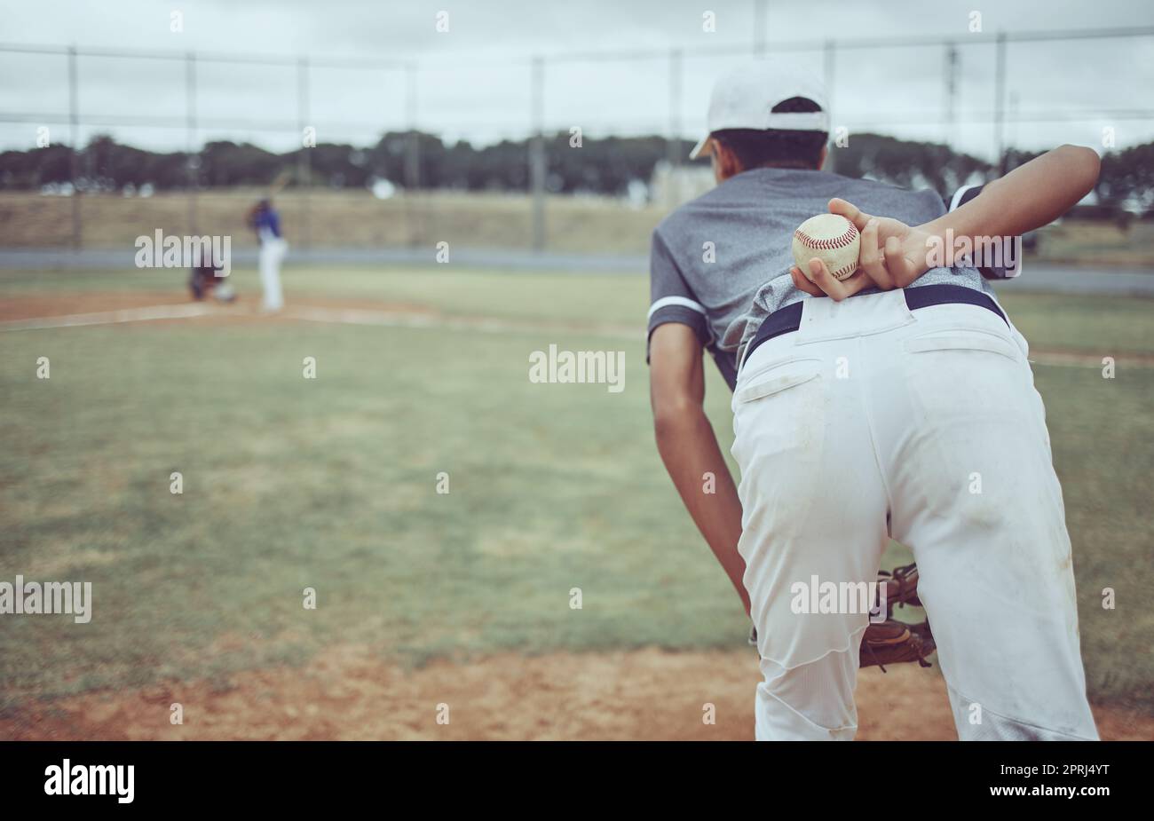 Baseball, baseball player and ball on back on baseball field ready to ...