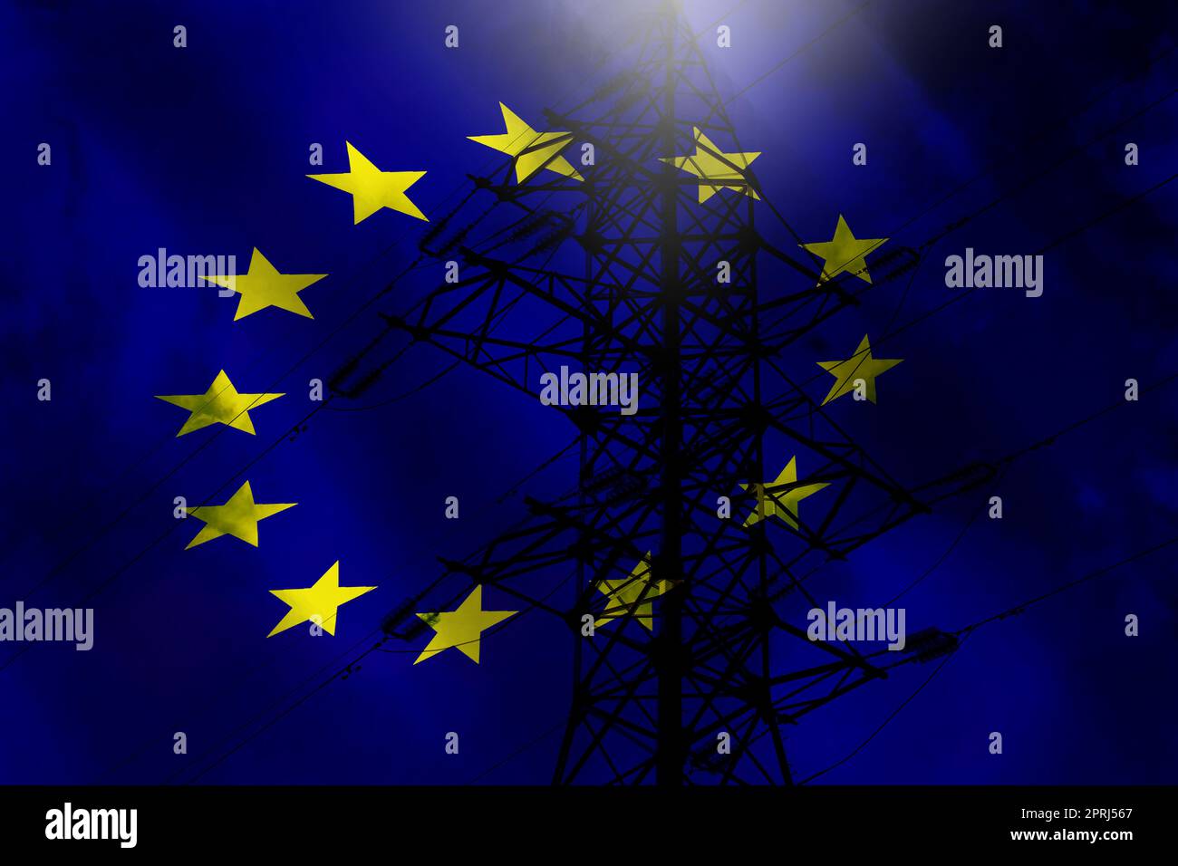 Power plant against the background of a dark sky and the flag of the ...