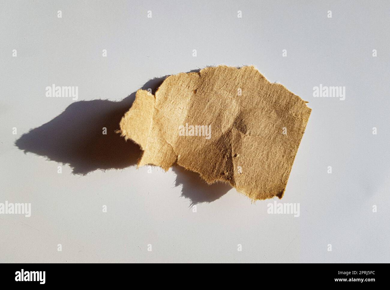 Recycled paper craft stick on a white background. Brown paper torn or ...