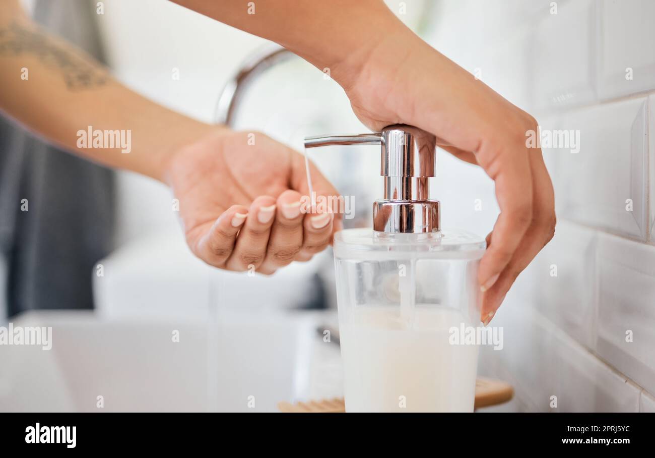 Hand washing, hygiene and soap dispenser with woman in bathroom rinsing ...