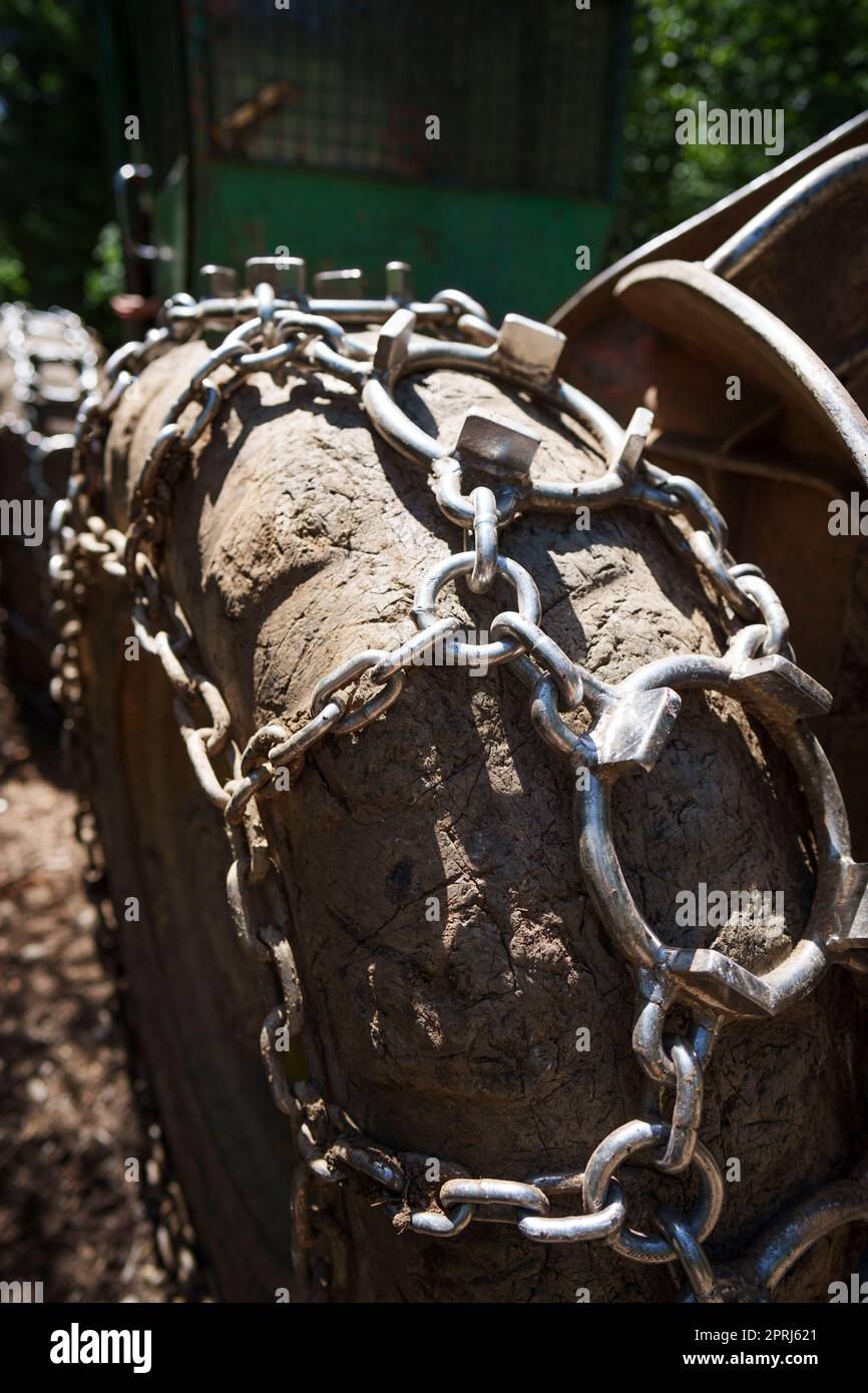 Traction chains on the big wheel of a forest log truck Stock Photo - Alamy