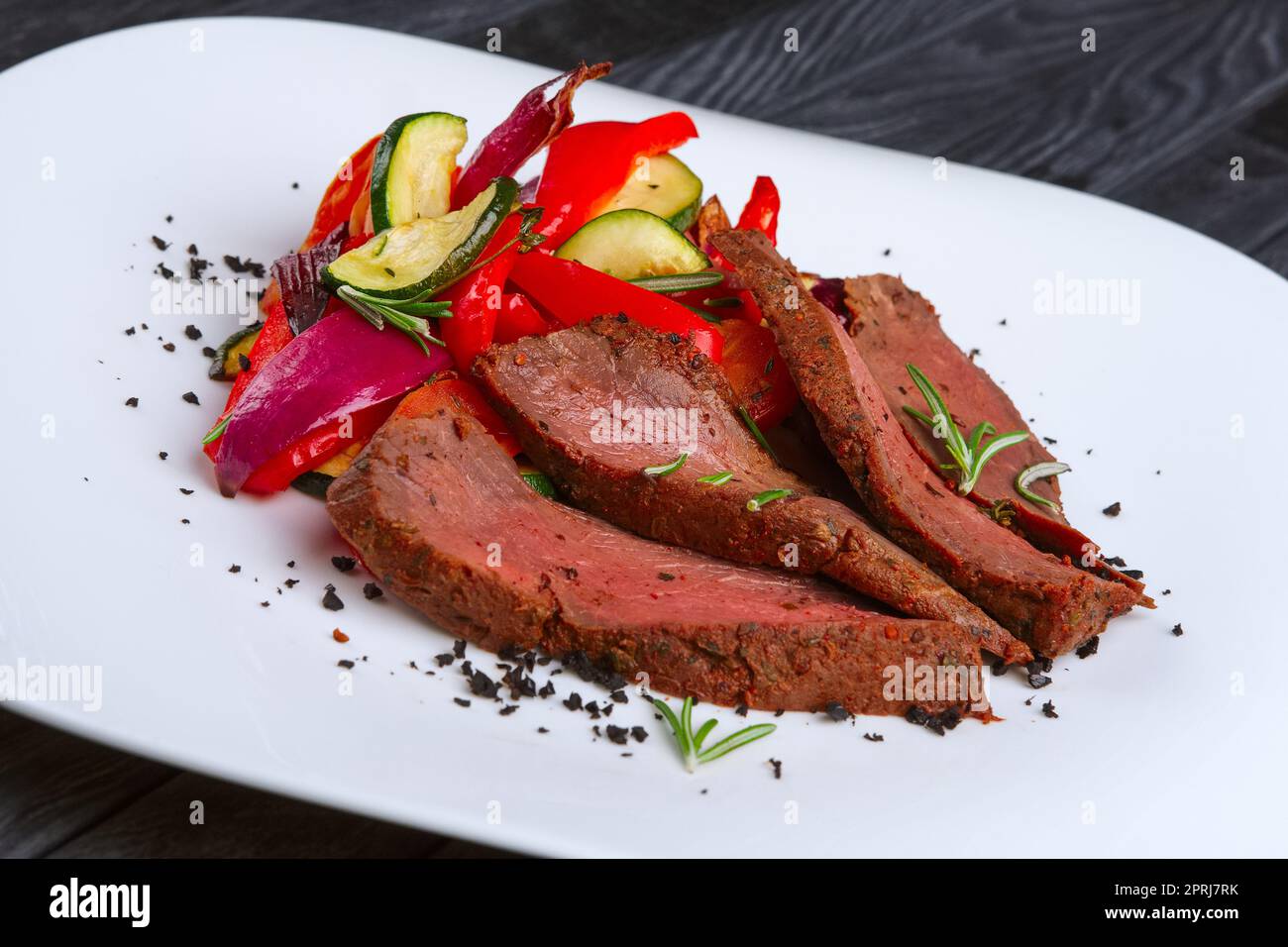 Roasted beef cutted on slices with grilled bell pepper, zucchini, onion ...