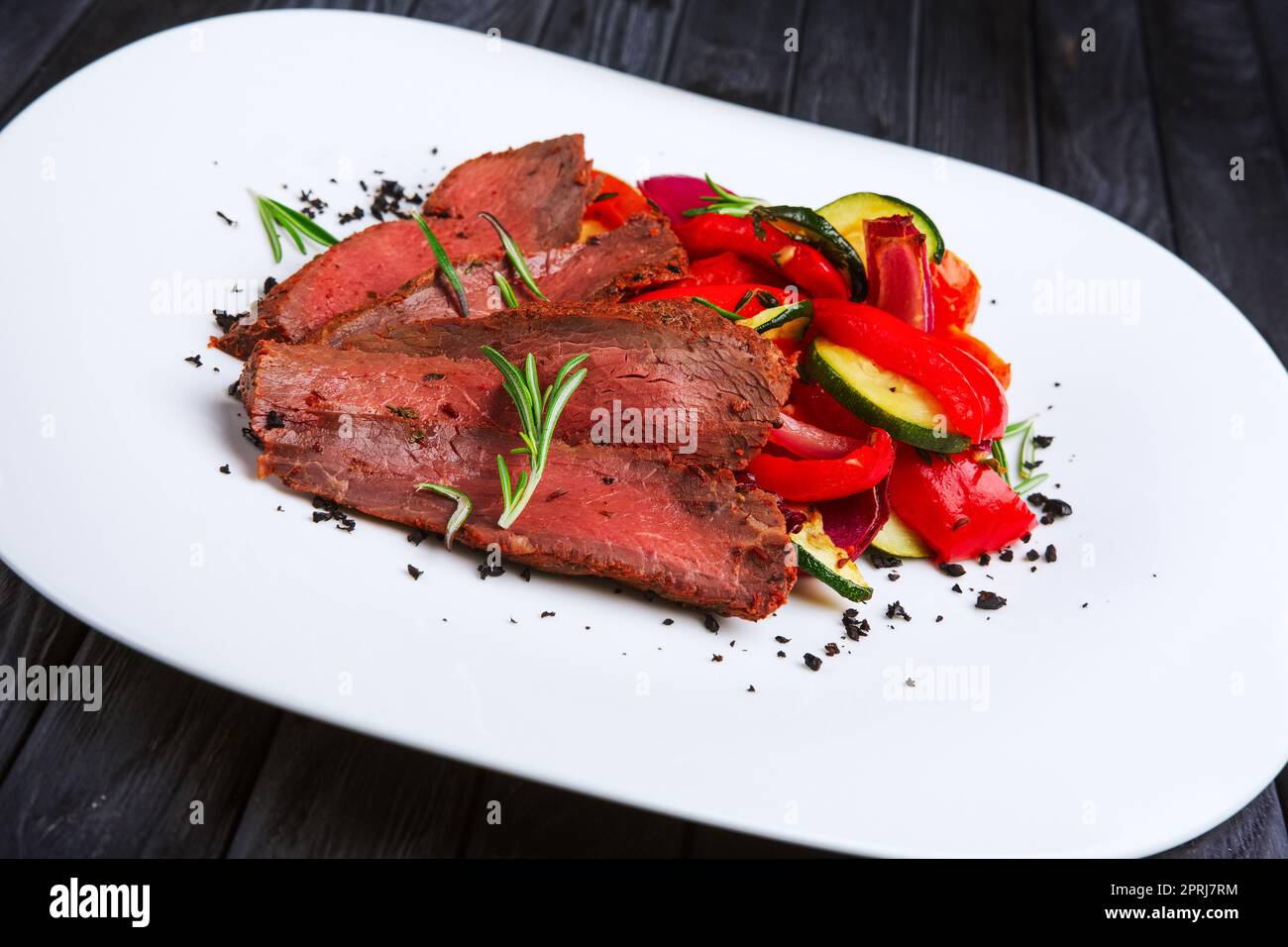 Roasted beef cutted on slices with grilled bell pepper, zucchini, onion ...