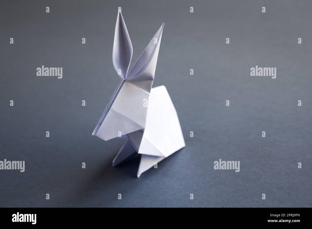 White paper rabbit origami isolated on a grey background Stock Photo ...