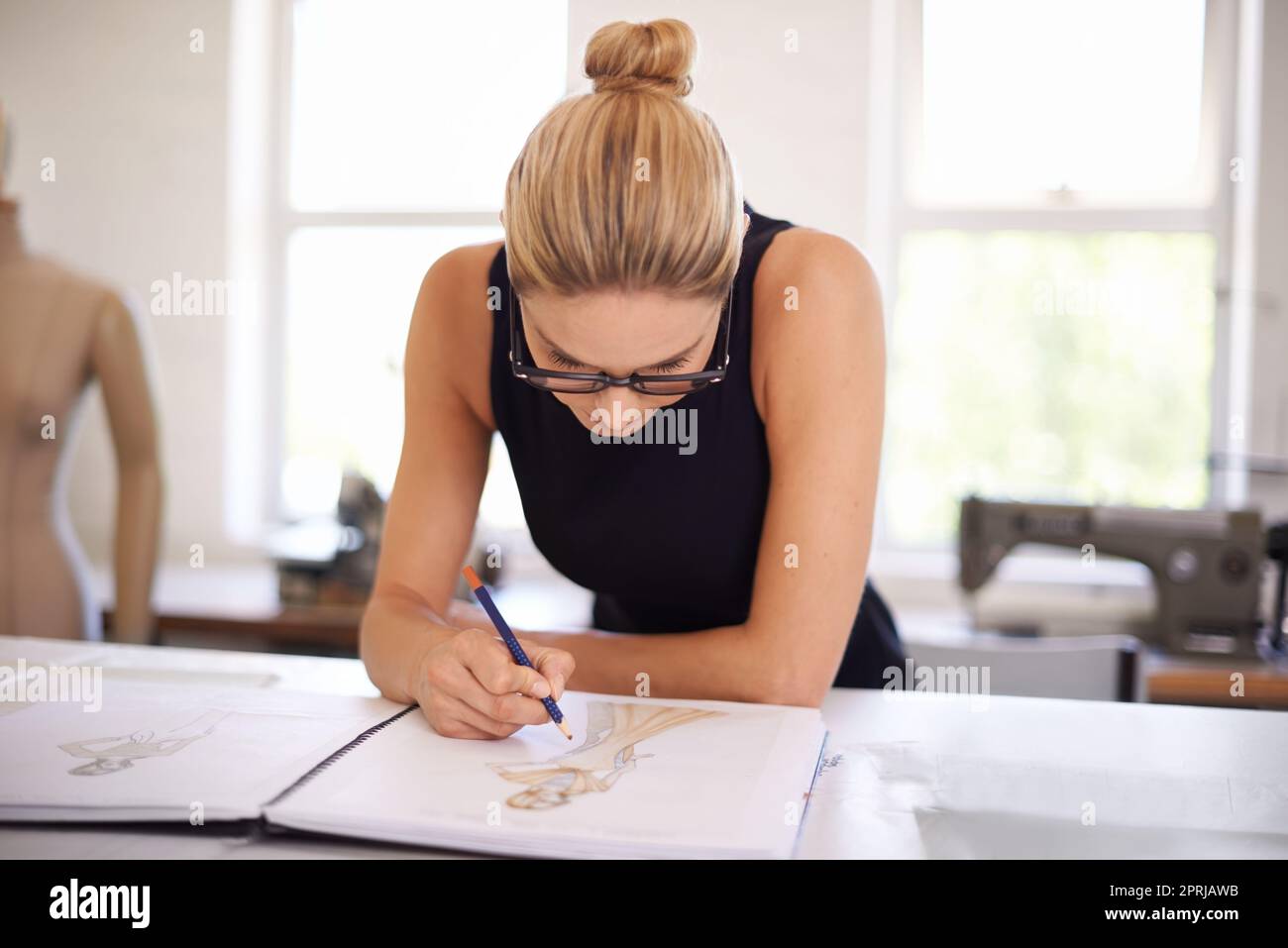 Designing the latest trends. an attractive young woman working on a ...