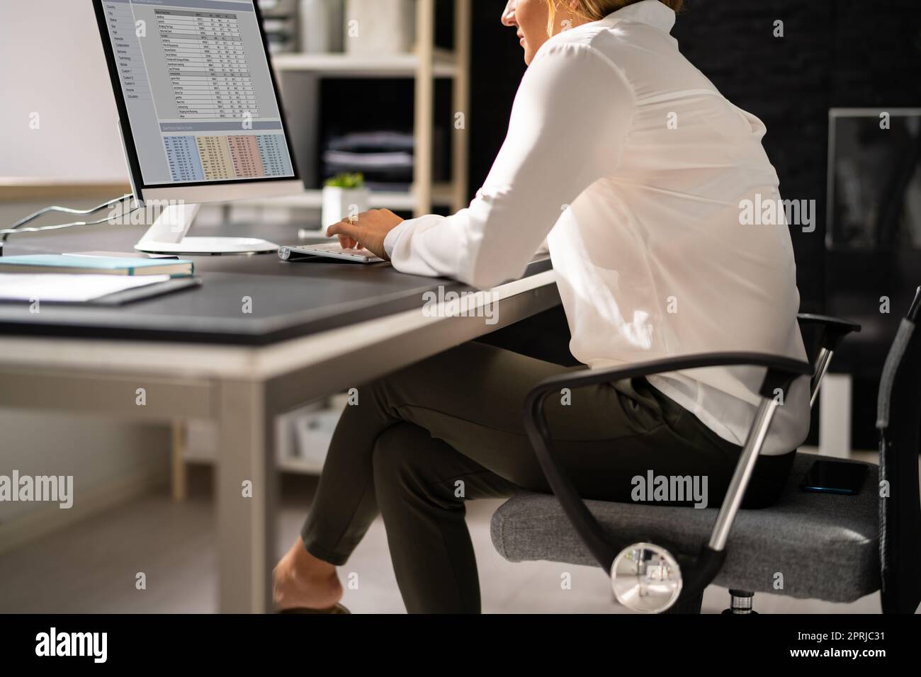 Woman Sitting In Bad Posture Working On Computer Stock Photo - Alamy