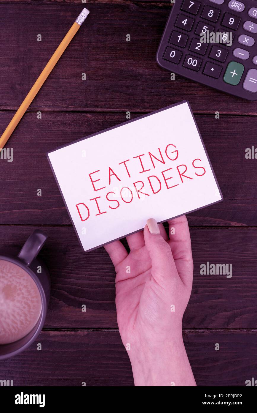 Hand writing sign Eating Disordersany of a range of psychological ...