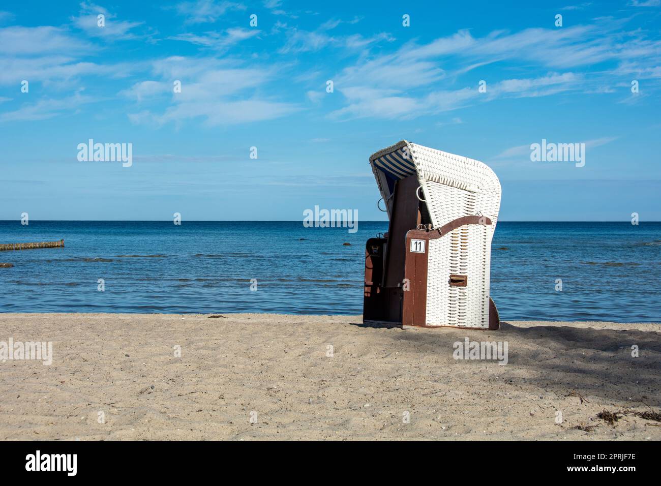A white traditional wicker beach baskets on the sandy beach with the ...