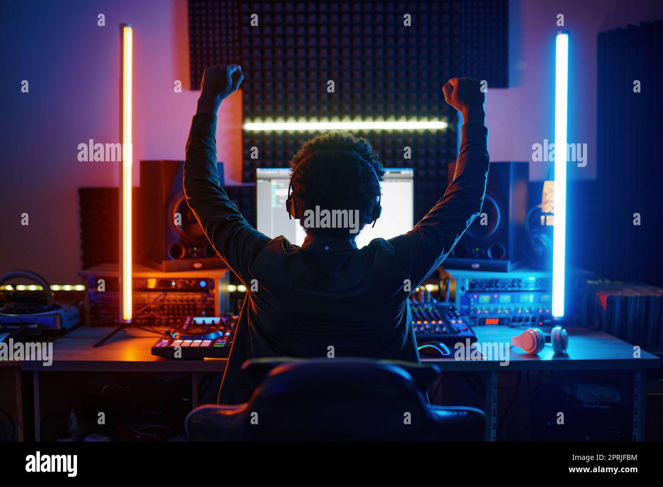 View from back on male music producer working in recording studio Stock ...