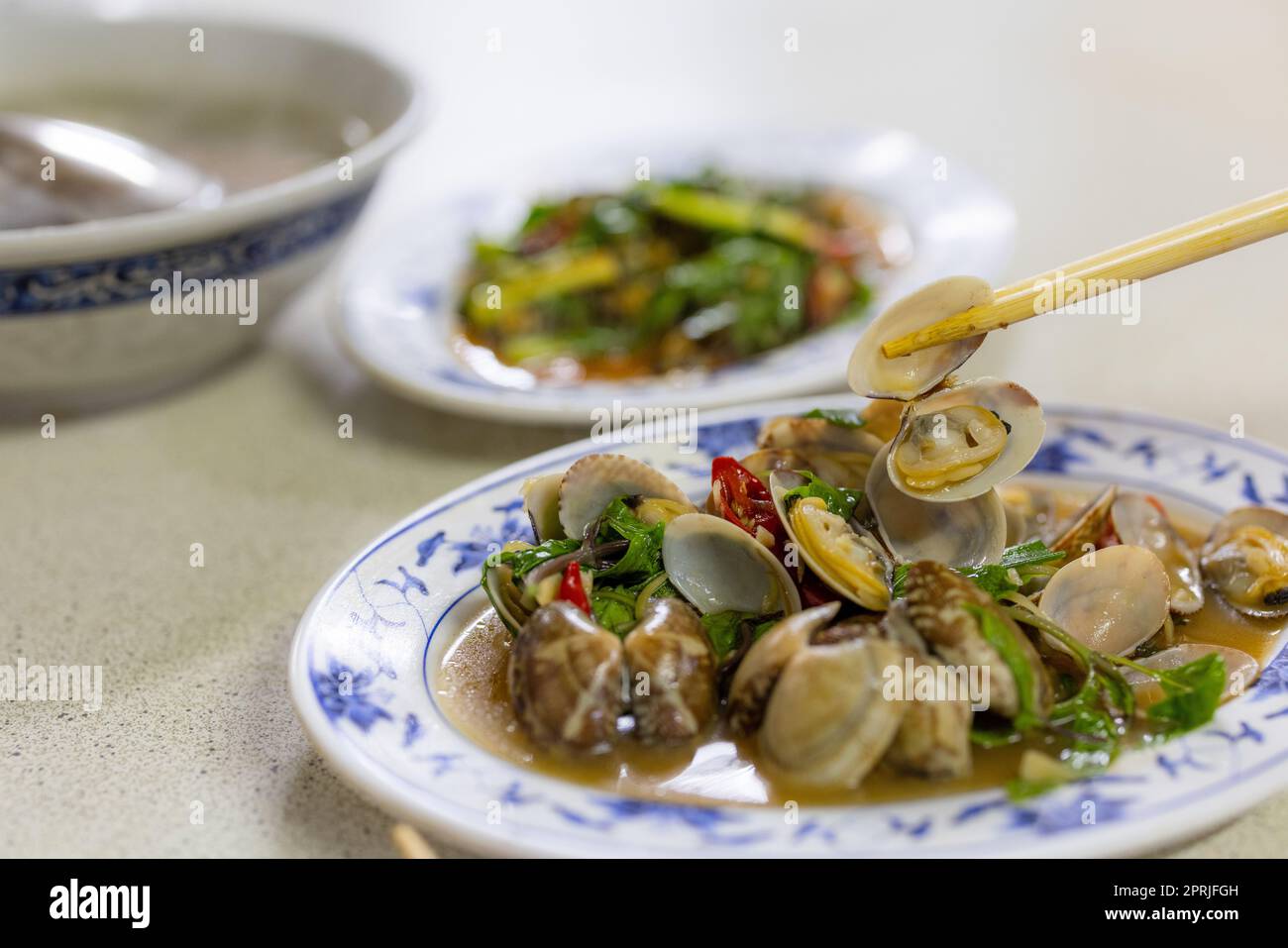 Asian fry clam dish in restaurant Stock Photo - Alamy