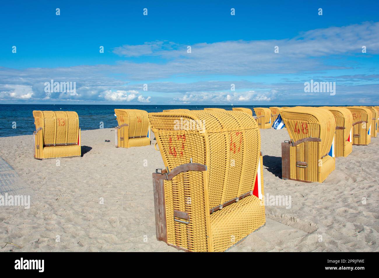 Brown traditional wicker beach baskets on the sandy beach with the ...