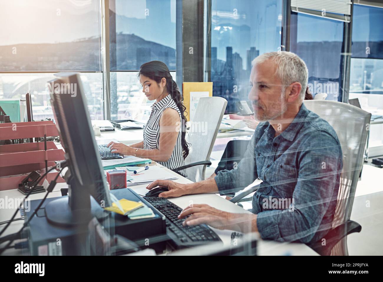 Working side by side. two colleagues working in the office Stock Photo ...