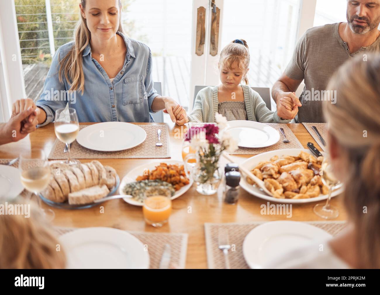 Young family praying sitting table hi-res stock photography and images ...