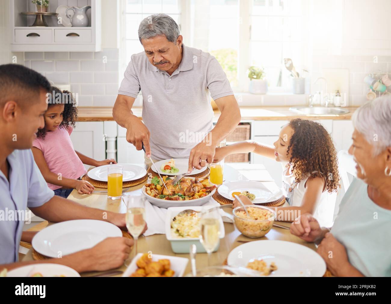 Family lunch, home celebration and grandparents hosting a dinner at ...