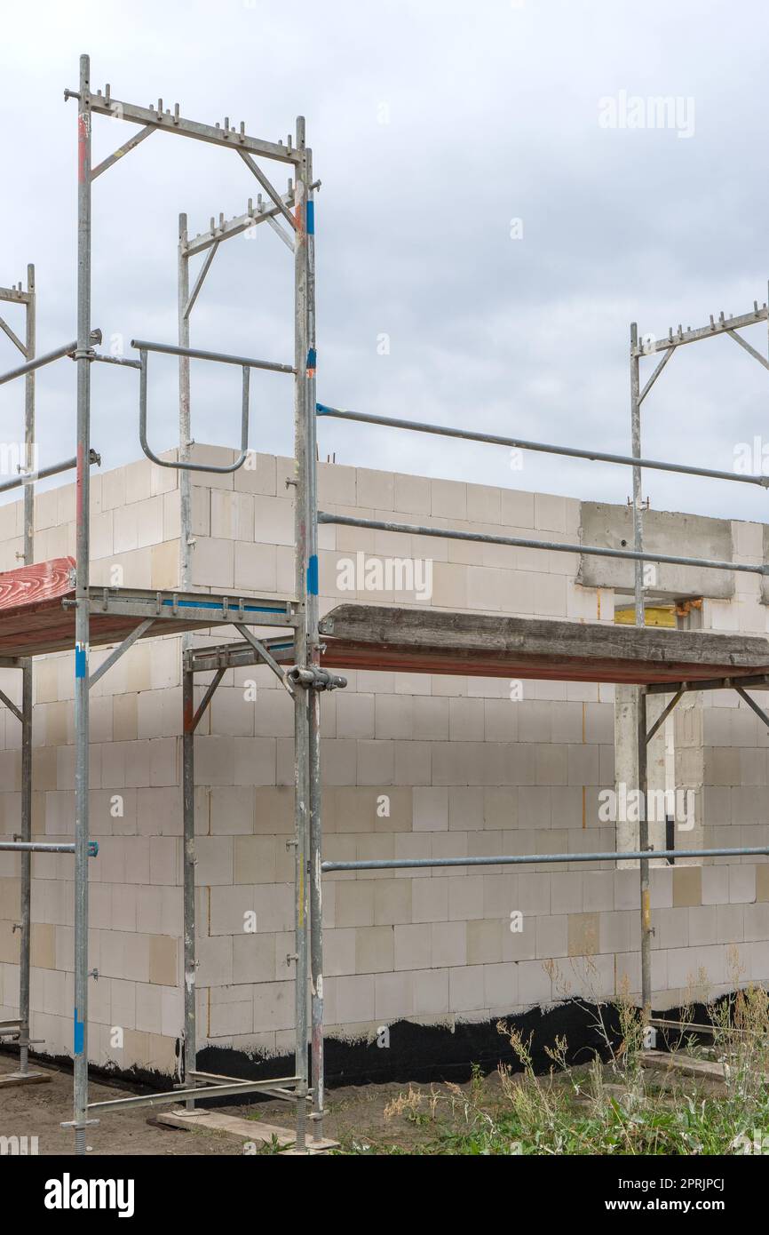 Shell construction of a building with scaffolding Stock Photo - Alamy