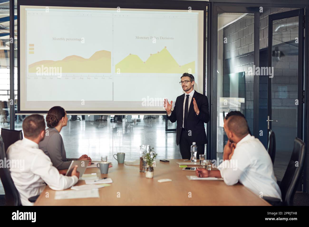 Talking profit and loss in the boardroom. an executive giving a ...
