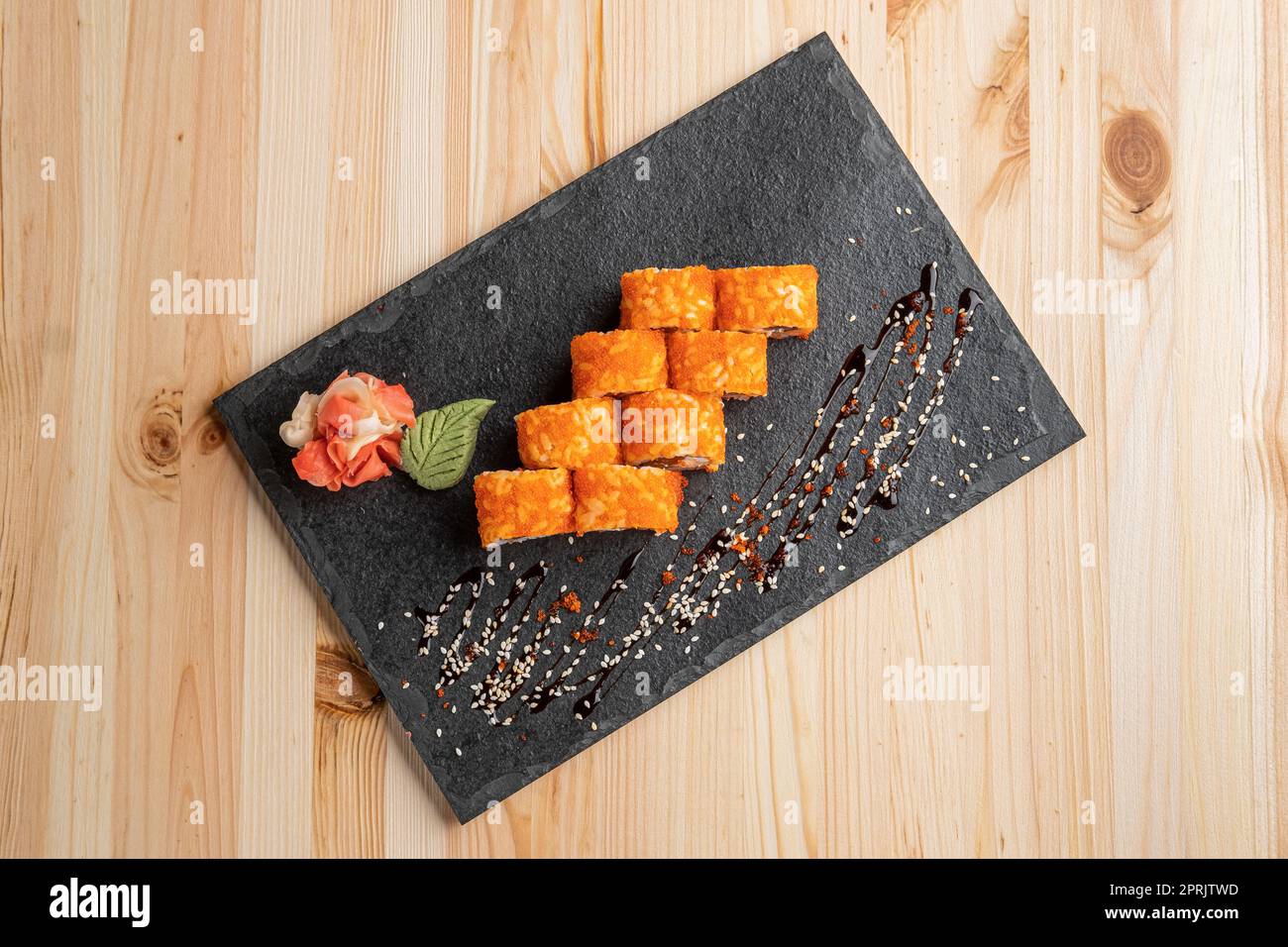 Set of rolls with wasabi and pickled ginger on stone serving board ...