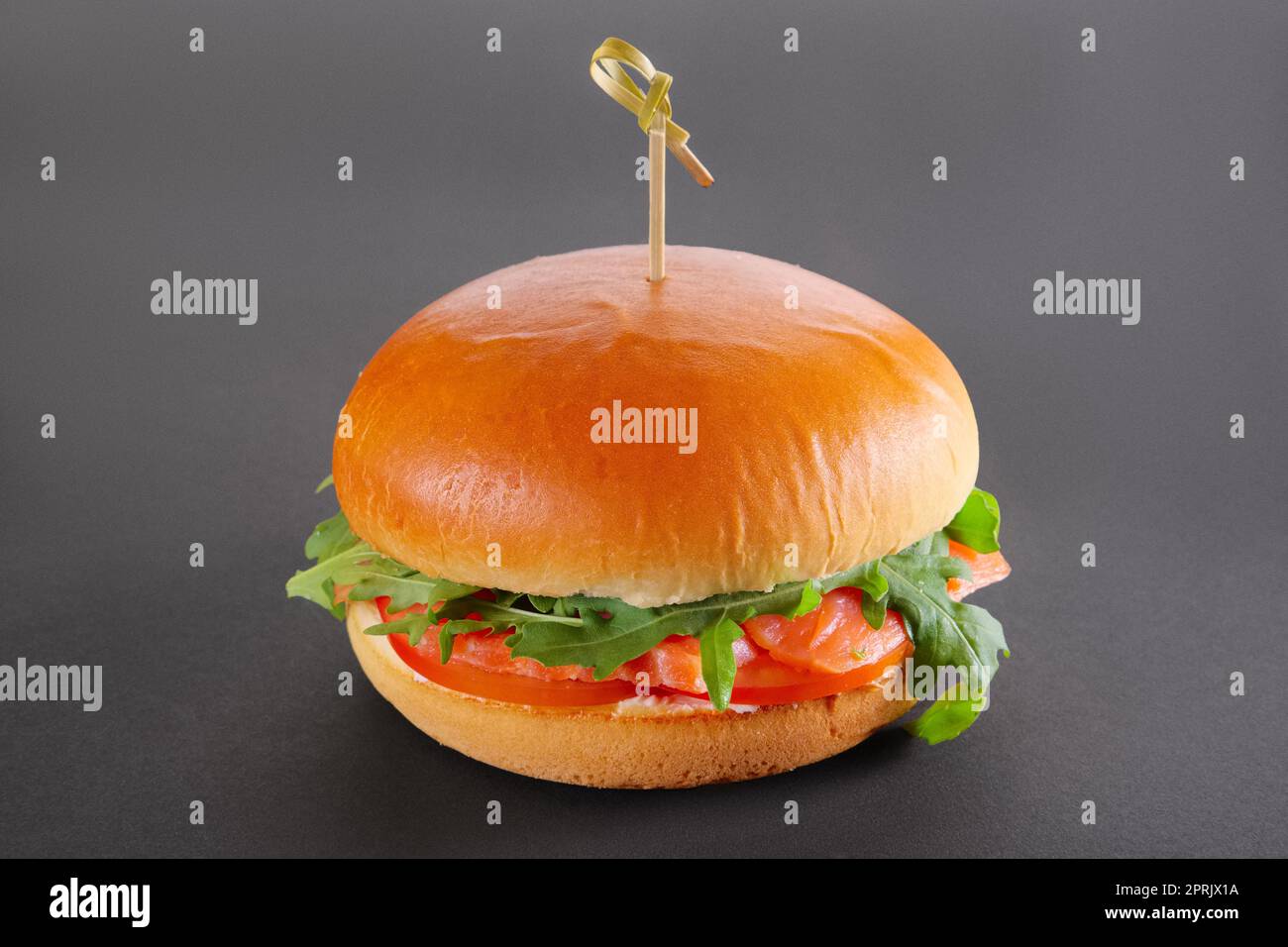 Simple burger with ham, tomato, pickled cucumber, arugula and soft ...