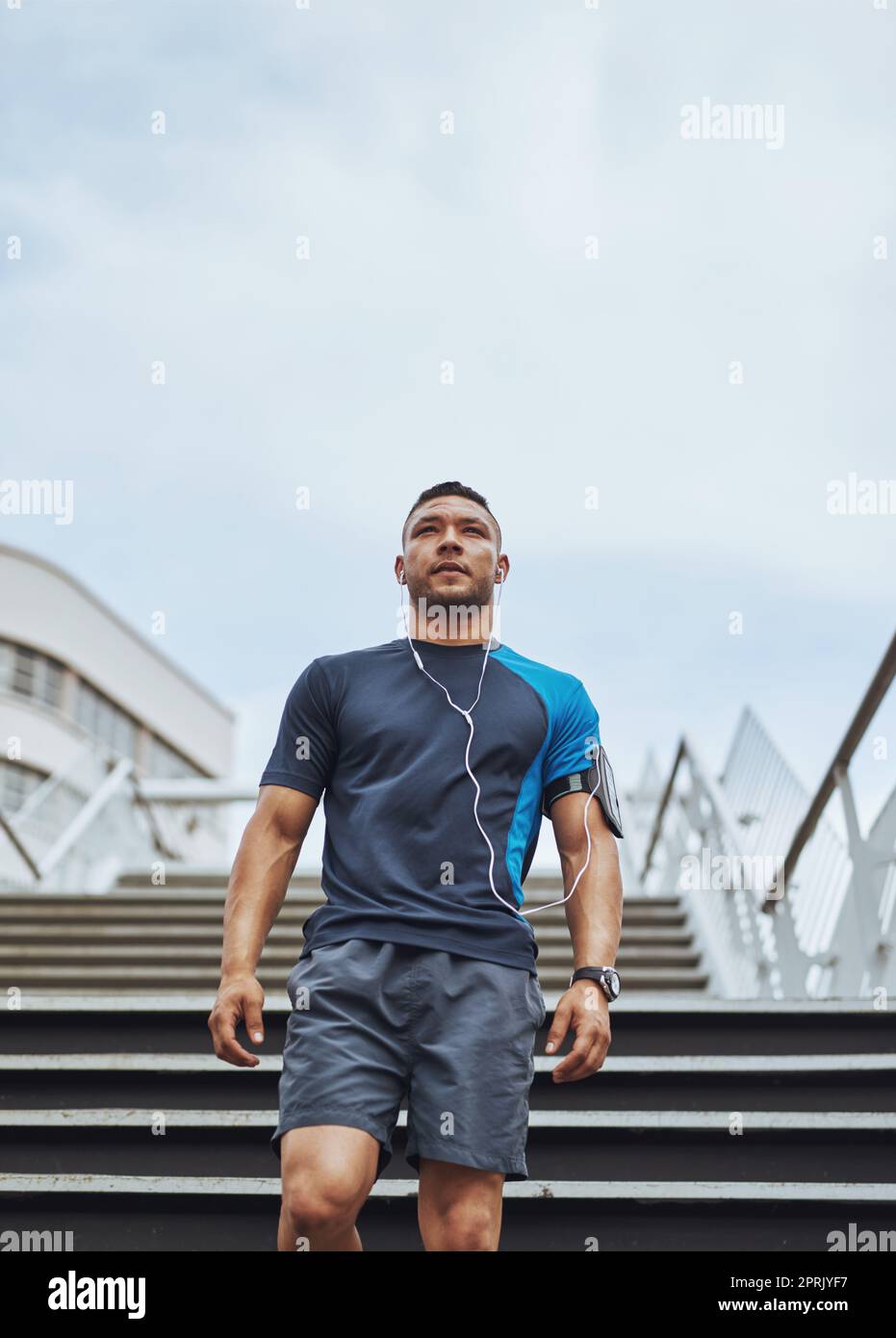 Fitness is his number one goal. Low angle shot of a male runner ...