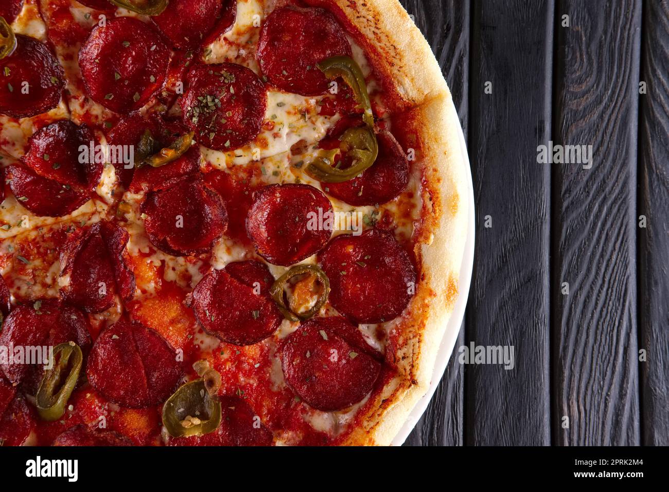 Hot pizza pepperoni with jalapeno pepper. Top view Stock Photo - Alamy
