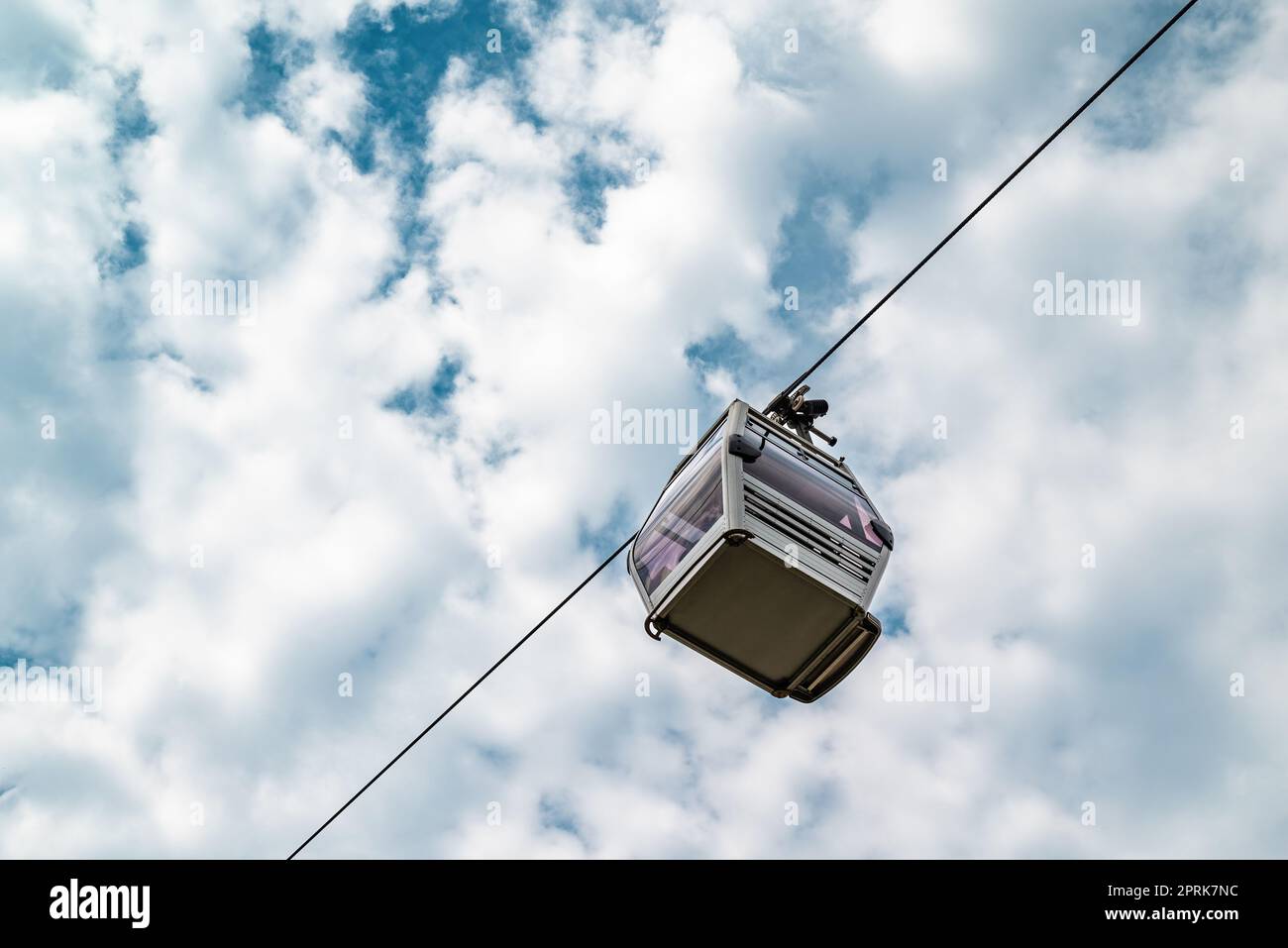 Bottom up view of cable car cabin in front of cloudy sky Stock Photo ...
