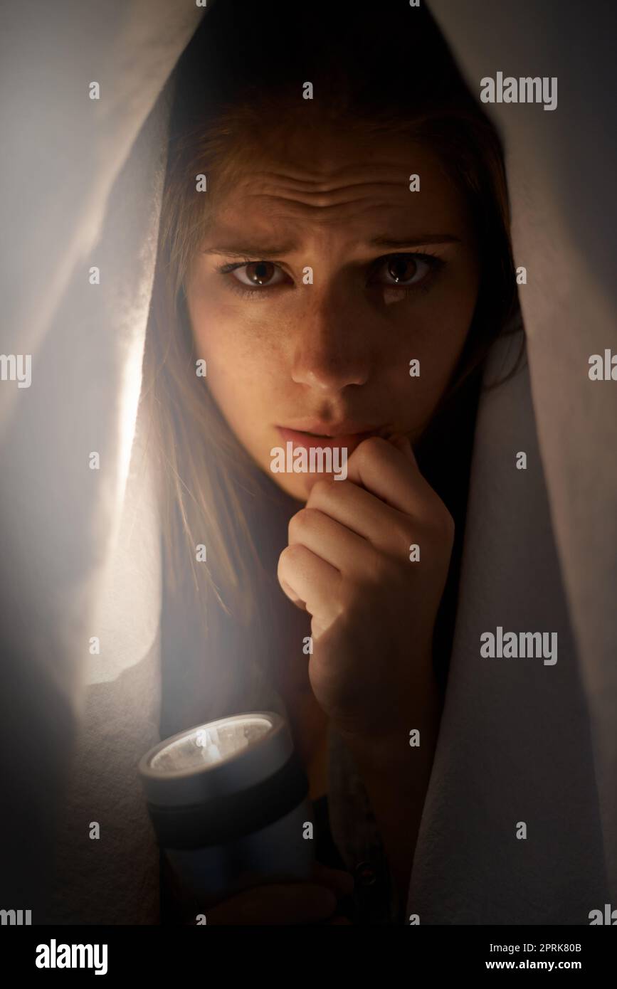 Do You Think Its Gone Yet A Young Woman Hiding Under The Bed Covers While Holding Her