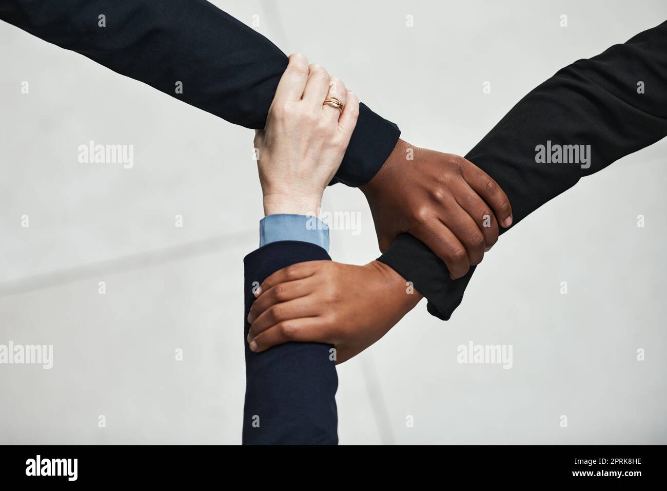Business success is hand built by teamwork. High angle shot of a group ...