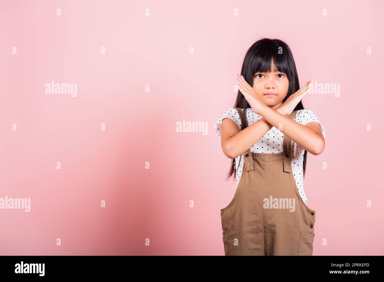 Stop gesture. Asian little kid 10 years old showing two hands cross ...