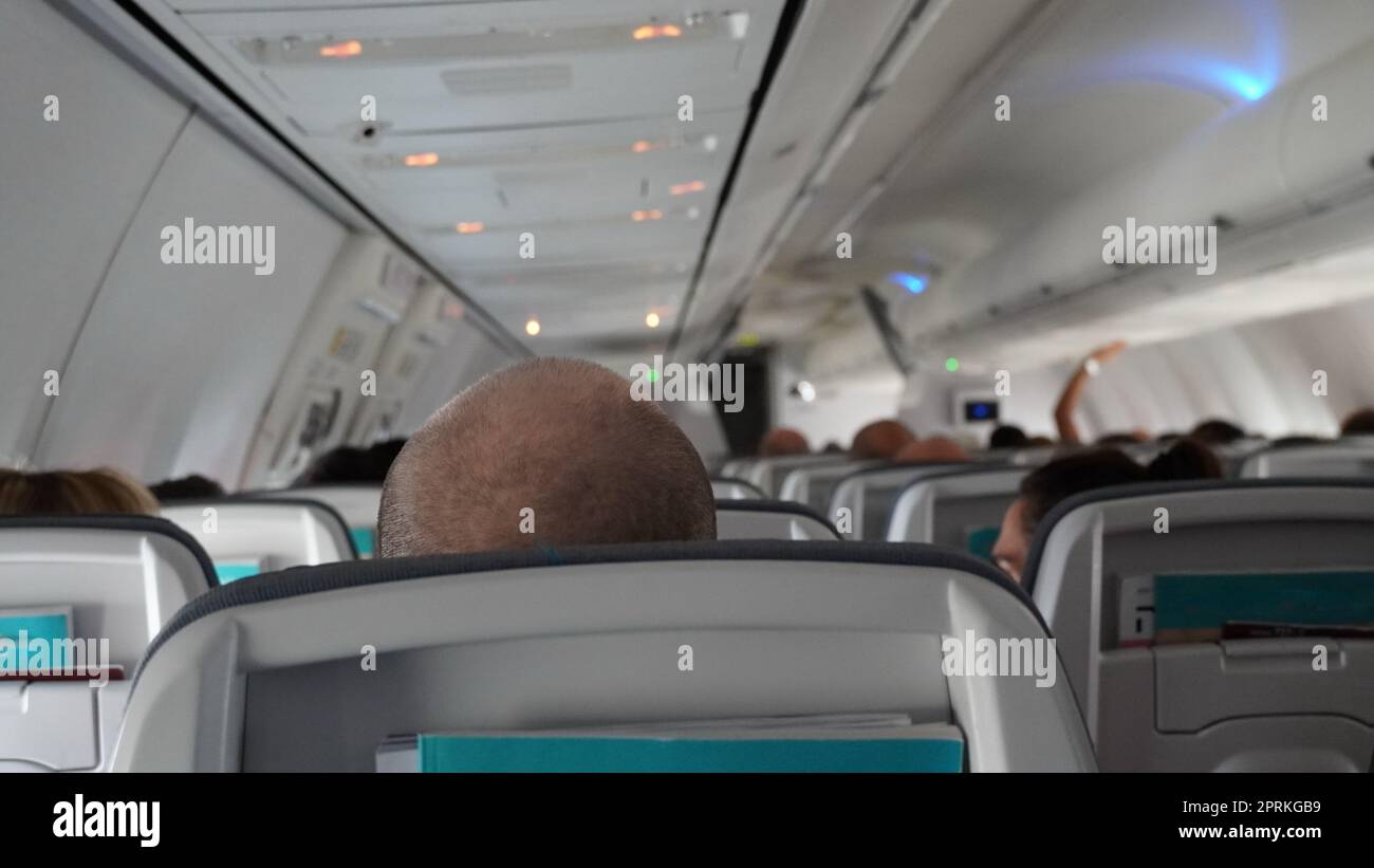 Passengers traveling by plane, shot from the inside of an airplane ...