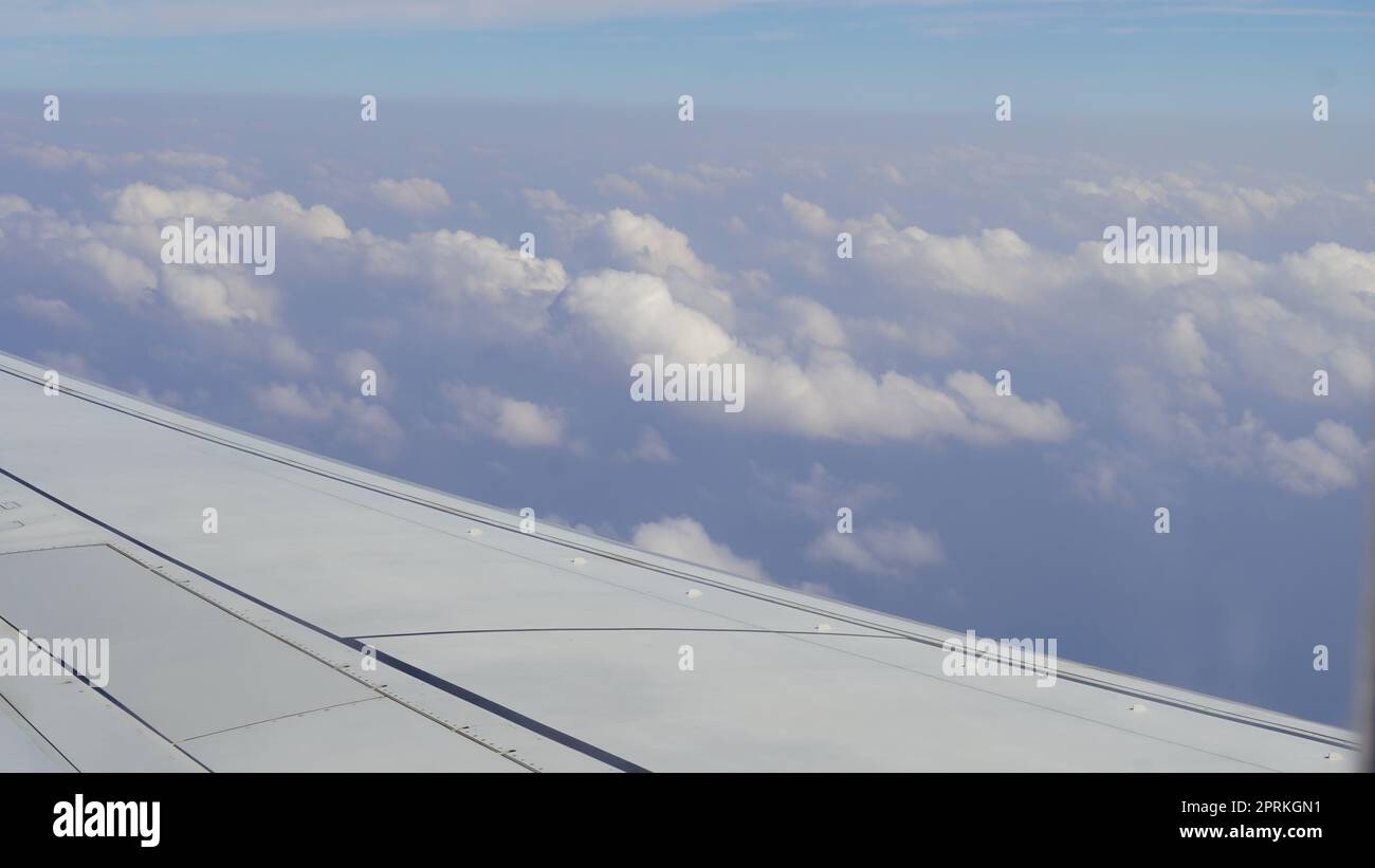 Wing of an airplane, passenger s view. Looking through the window of a ...
