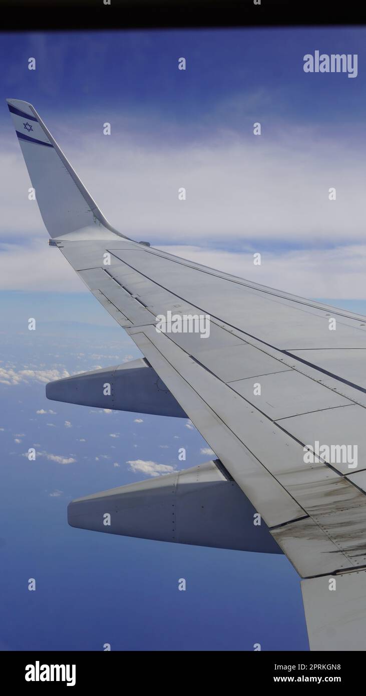 Wing of an airplane, passenger s view. Looking through the window of a ...
