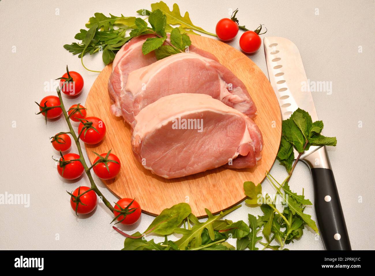 Layers of meat sliced from pork tenderloin for cooking escalope Stock ...