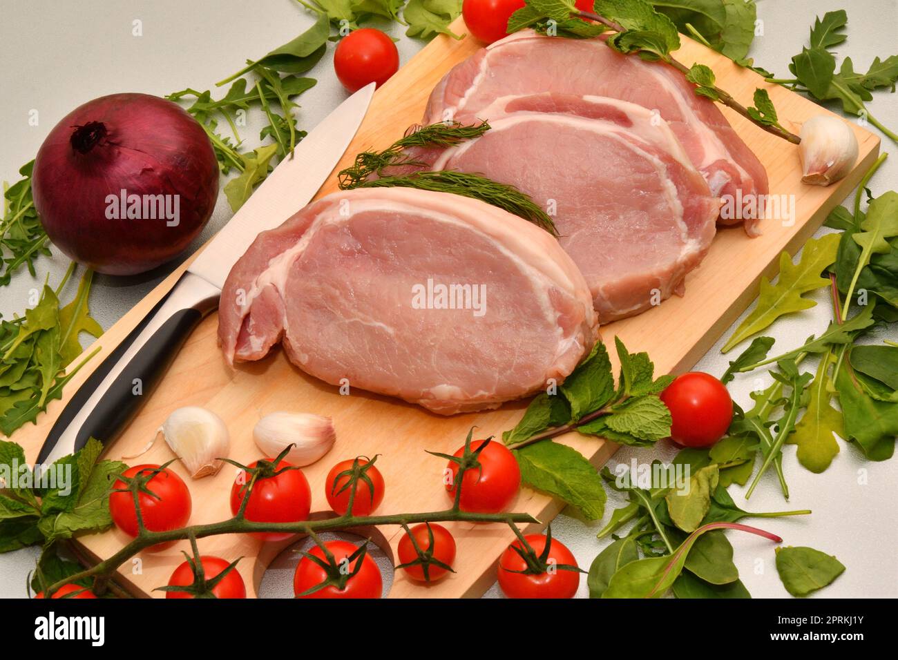Layers of meat sliced from pork tenderloin for cooking escalope Stock ...