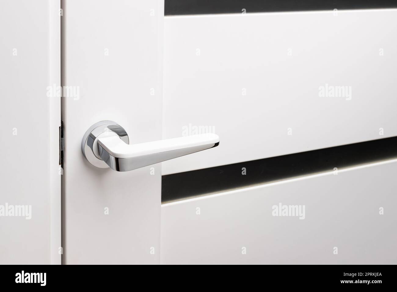 Door handles elements close up. Door handle on white closed doors in ...