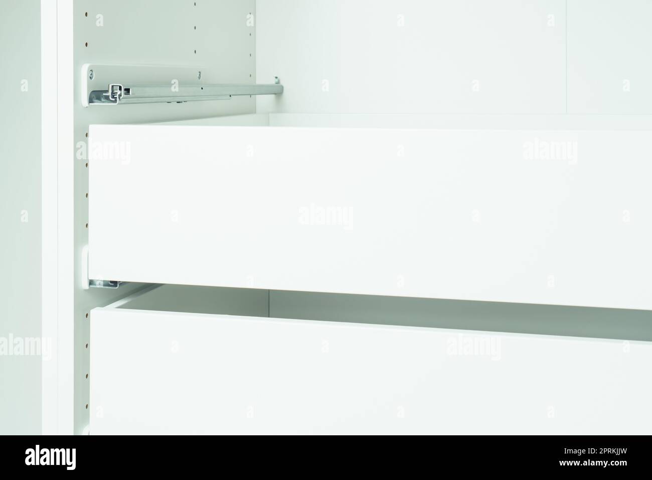 Drawer rail inserted into cabinet, fixed with self-tapping screws ...