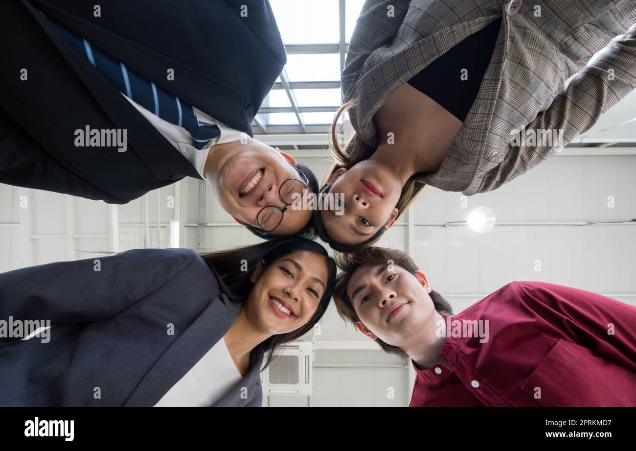 Portrait closeup bottom view happy faces of employees team standing in ...