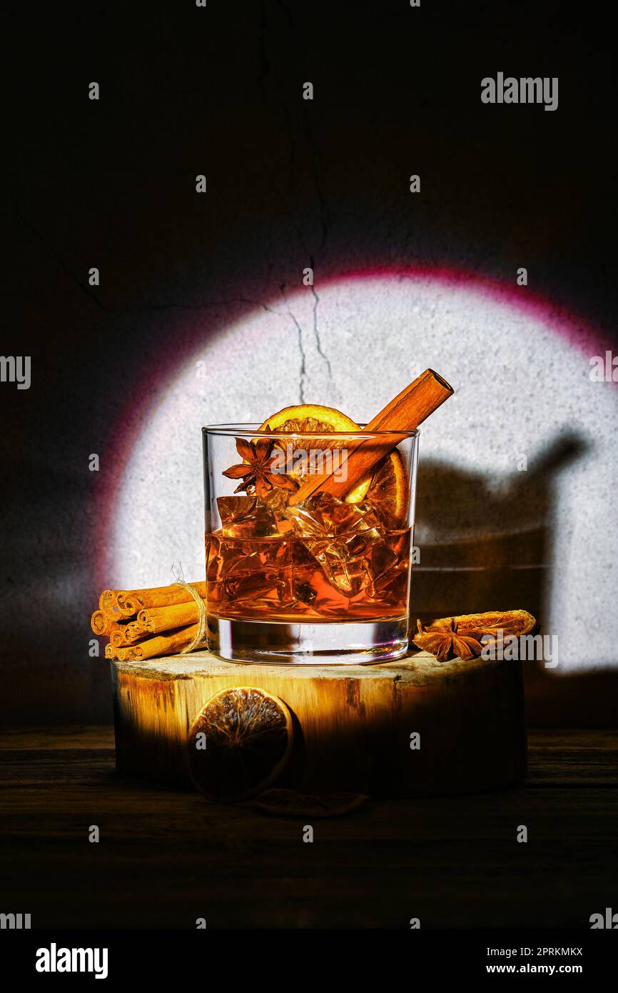 Cold cocktail with brandy and orange liquor, cinnamon and star anise on ...