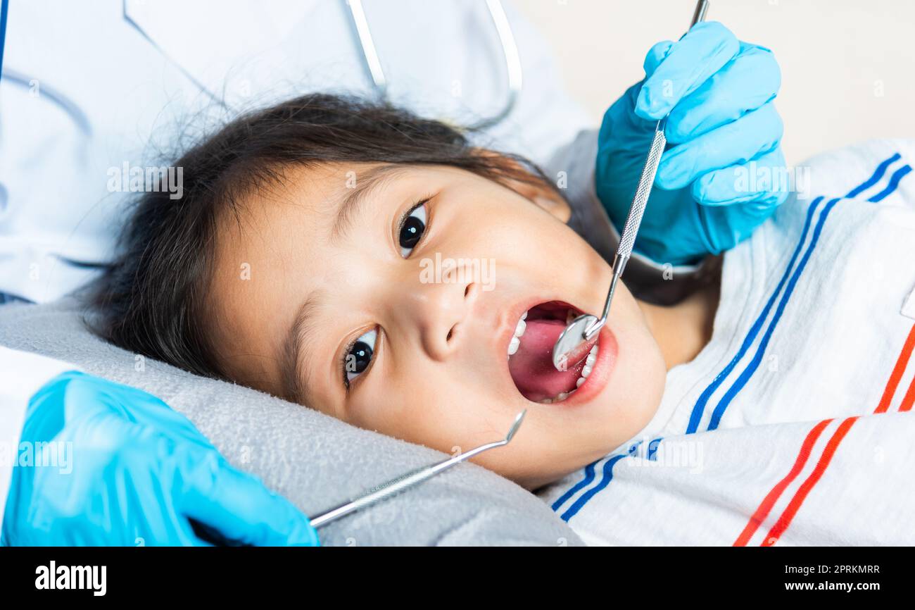 Dental kid health examination. Asian dentist making examination ...