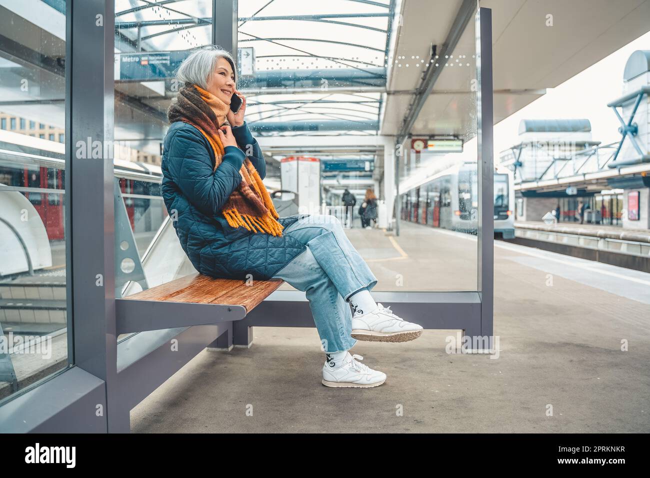 Senior woman at tram station hi-res stock photography and images - Alamy
