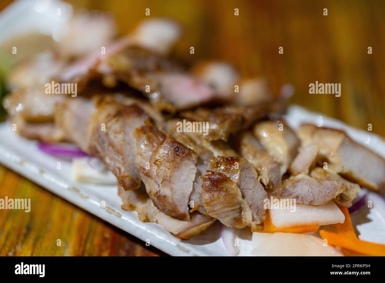 Grilled slice of pork dish in restaurant Stock Photo - Alamy