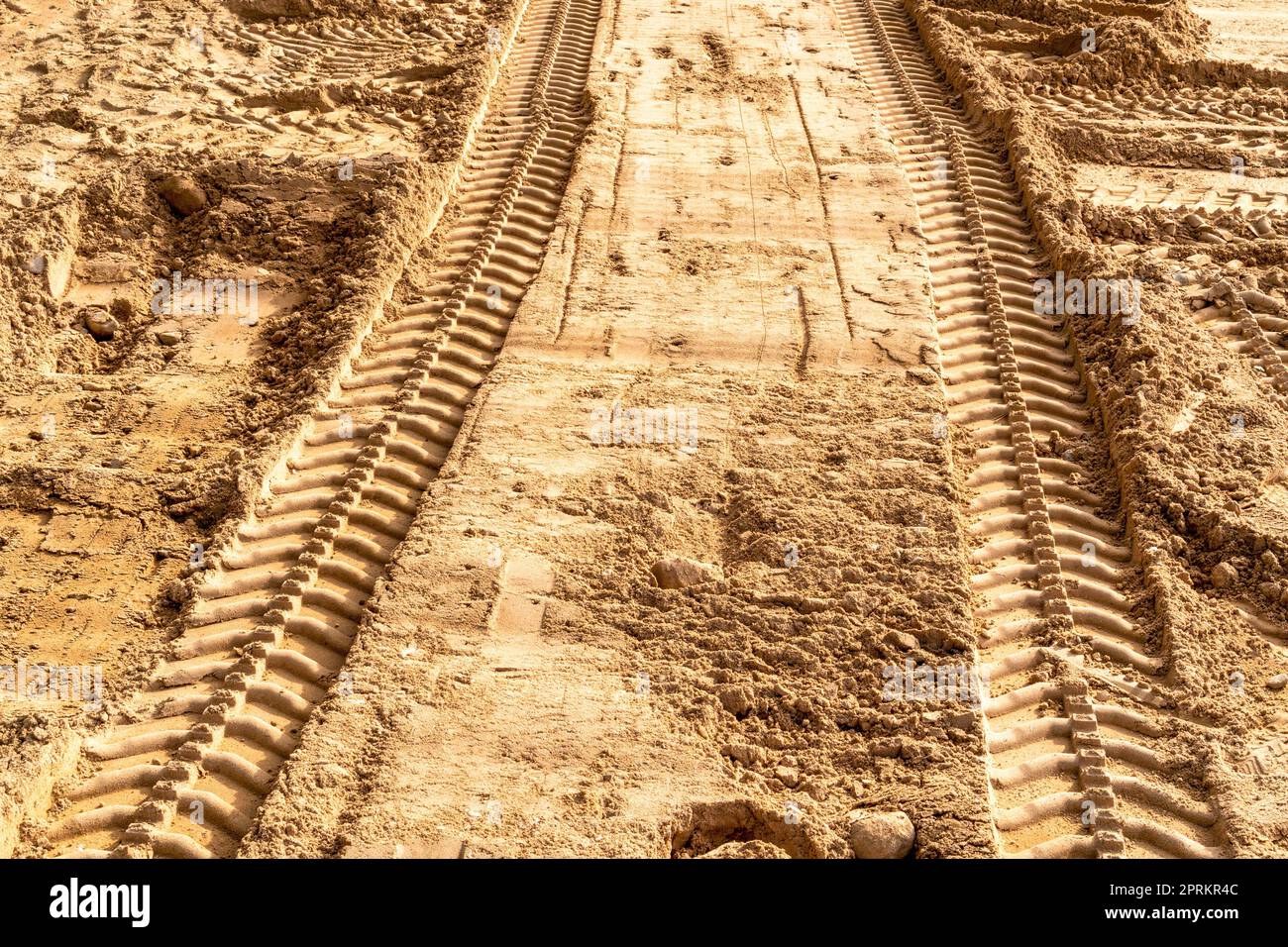 Deep tire tracks in the sand. Tire marks in the ground at a ...