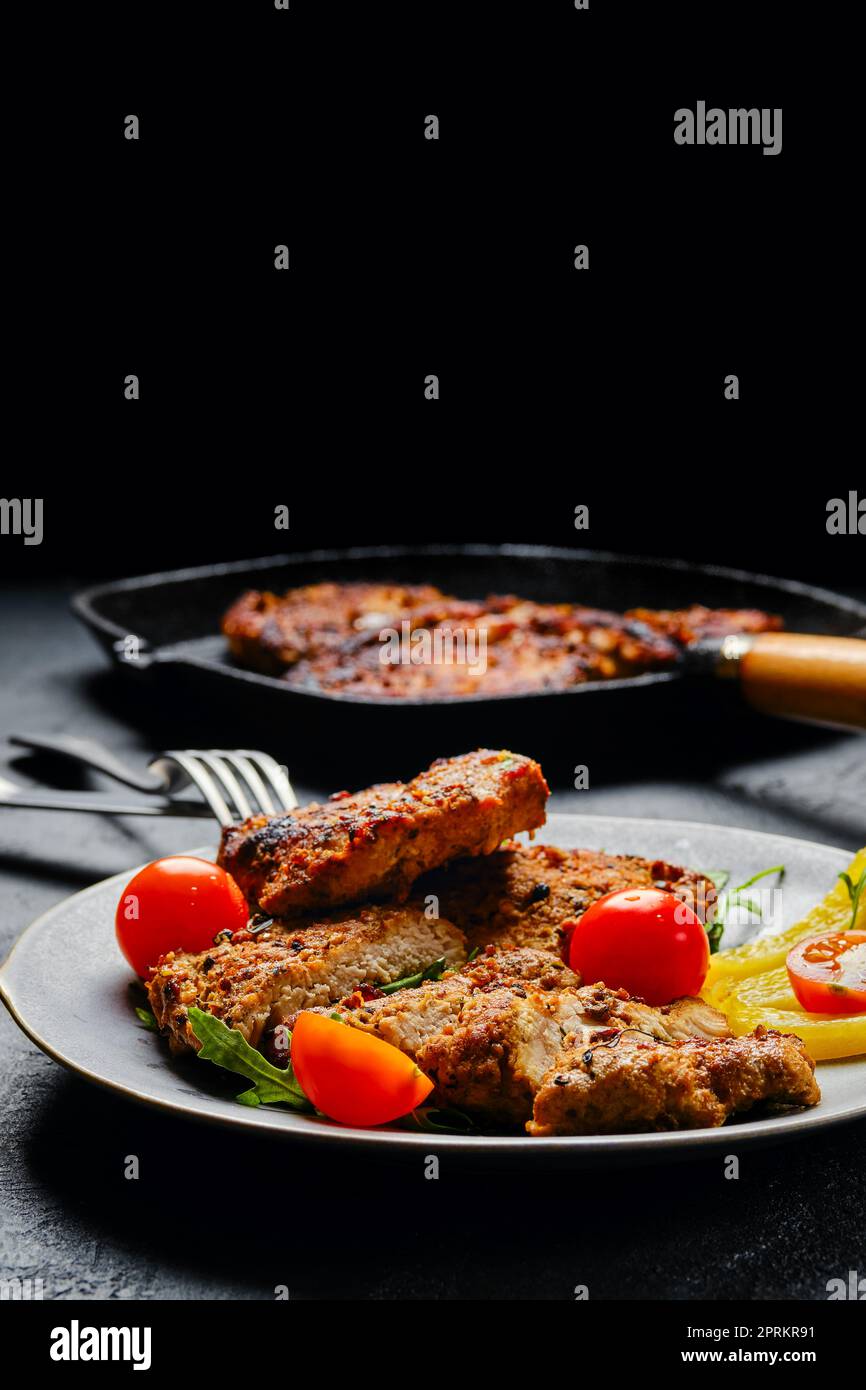 Pork chop fillet baked in oven with seasoning and herbs Stock Photo - Alamy