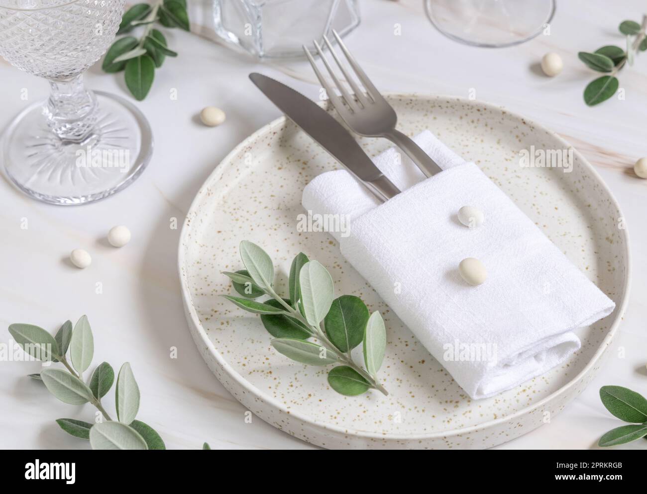 Elegant wedding Table setting decorated with eucalyptus branches and ...