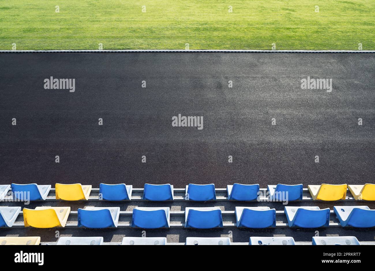 top view of tribune row empty plastic seats in blue and yellow near an ...
