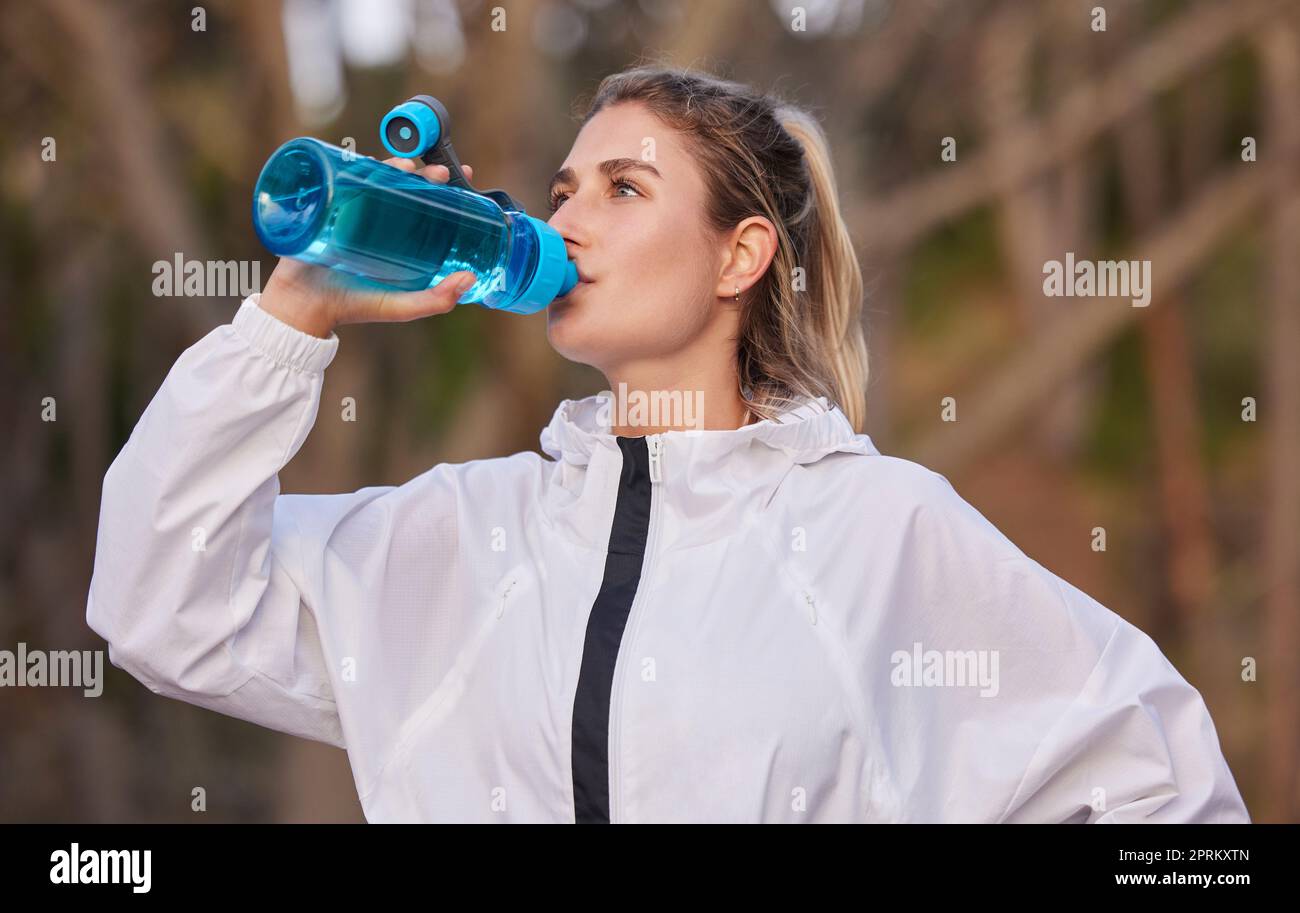 Fitness, health and runner woman with water bottle for hydration break ...