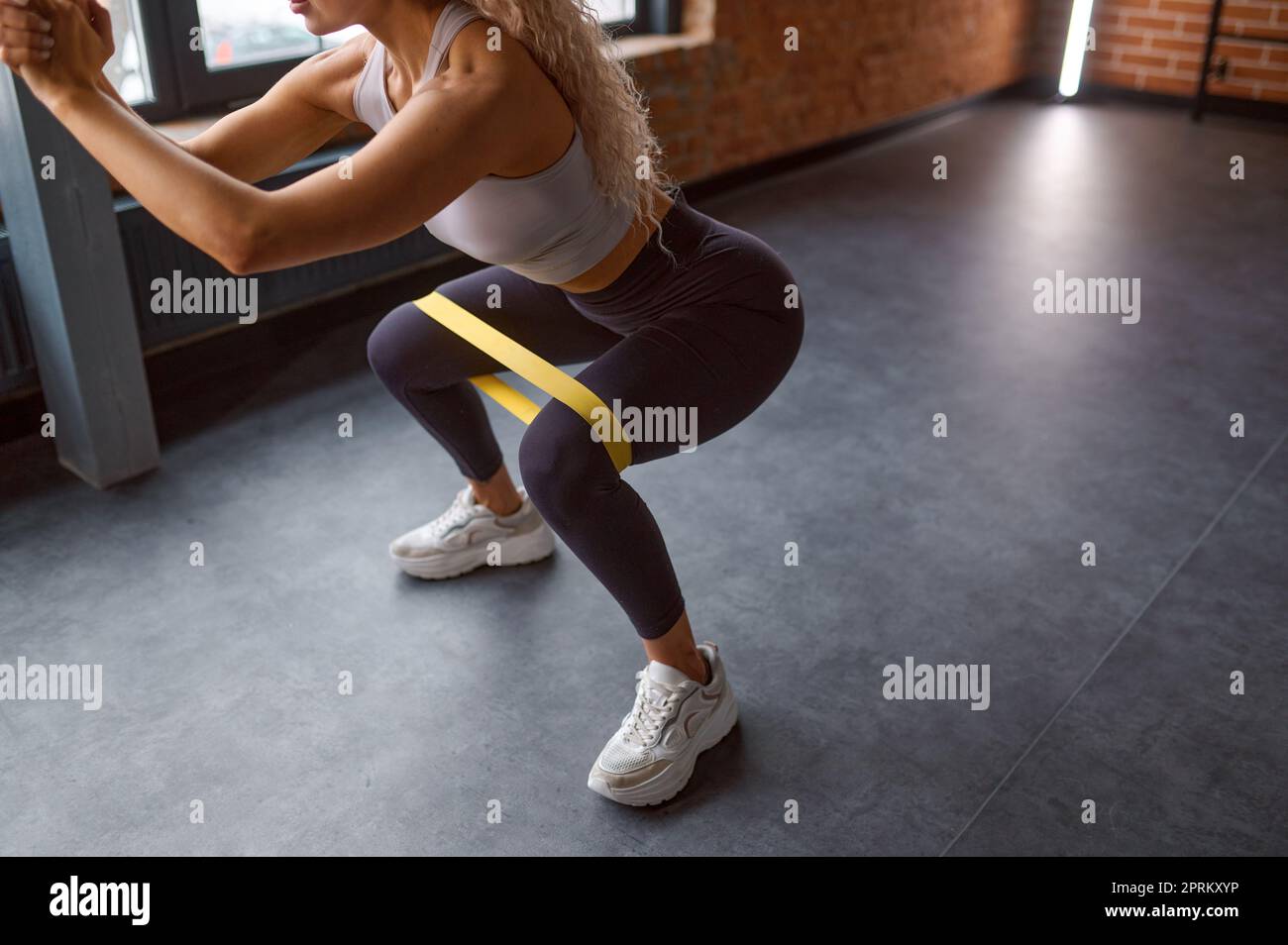 Woman training with fitness rubber band at gym sport club. Exercise ...