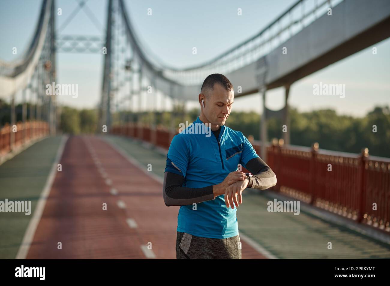 Runner checking smartwatch controlling pulsations after exercise. Sport ...