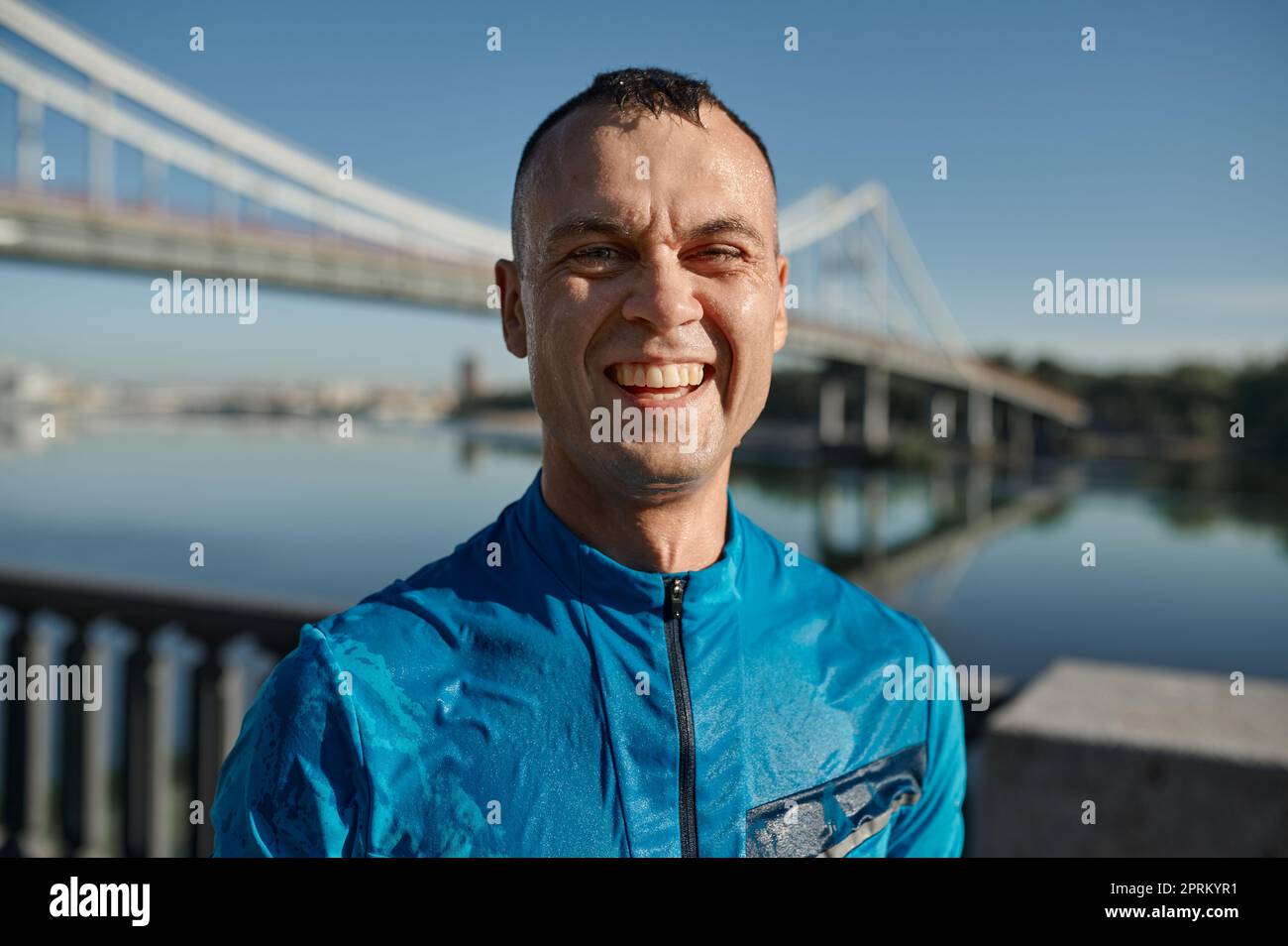 Headshot portrait of happy smiling athlete man runner with wet face ...