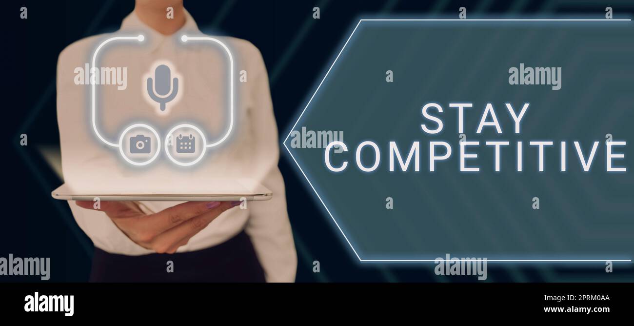 Sign displaying Stay Competitive, Word Written on moving from the use ...